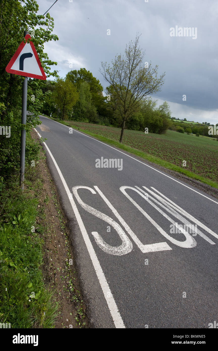 Narrow country road with slow sign, road signage and precautions on ...