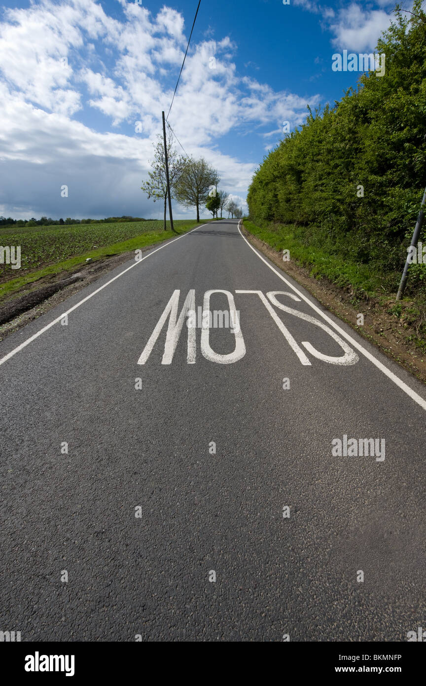 Narrow country road with slow sign, road signage and precautions on ...