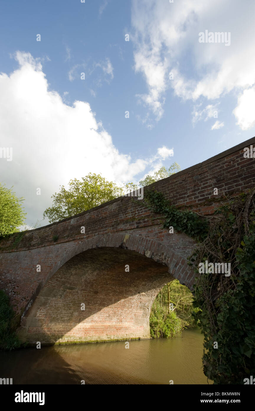 canal bridge with road crossing next to tow path made of brickwork ...