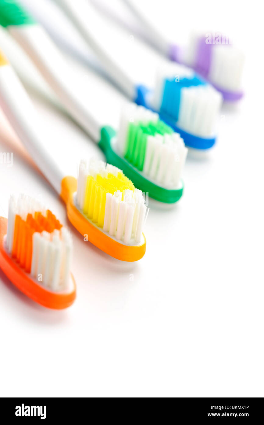 Close up of multicolored toothbrushes on white background Stock Photo ...
