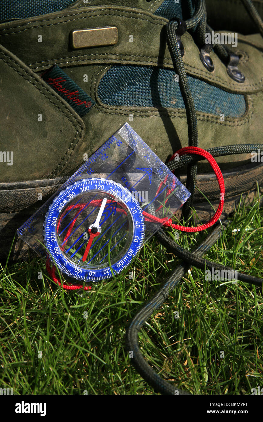 A walking boot and a compass Stock Photo - Alamy