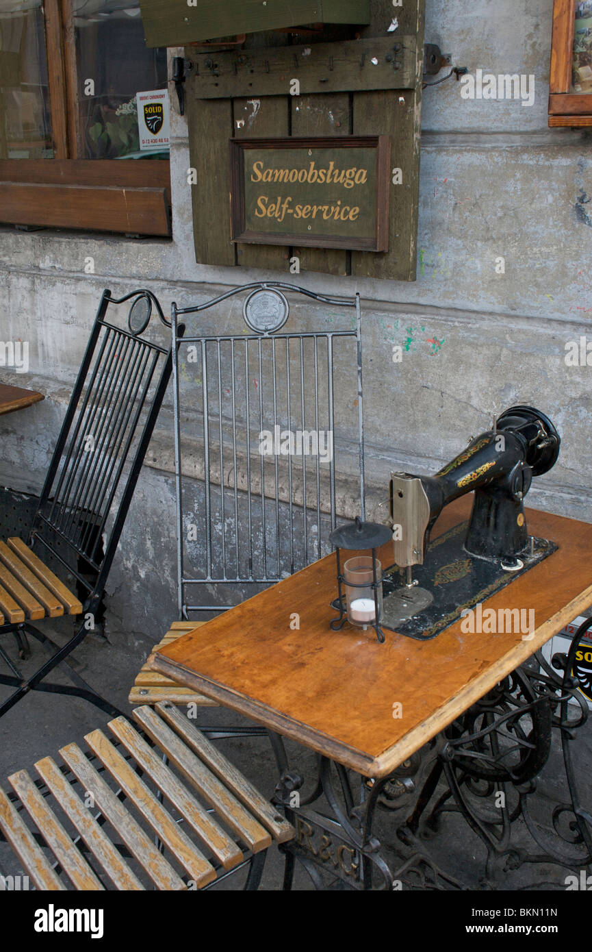 Outside table at Cafe Singer with Singer sewing machine and slatted ...