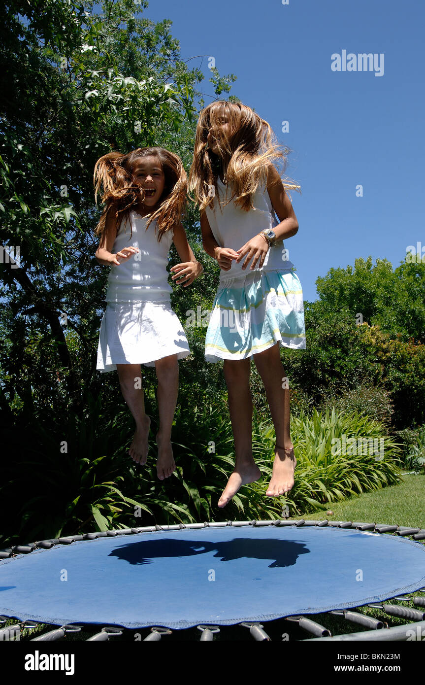 Girls jumping in a trampoline Stock Photo - Alamy