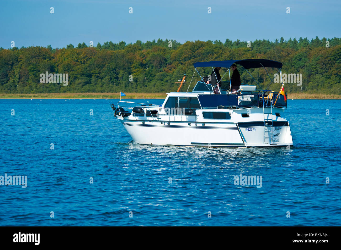 Charter yacht in front of forest, lake near Muritz, Mecklenburg Western ...