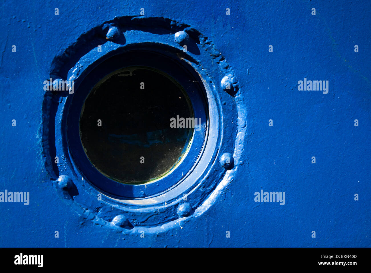 The port hole of a blue ship Stock Photo - Alamy