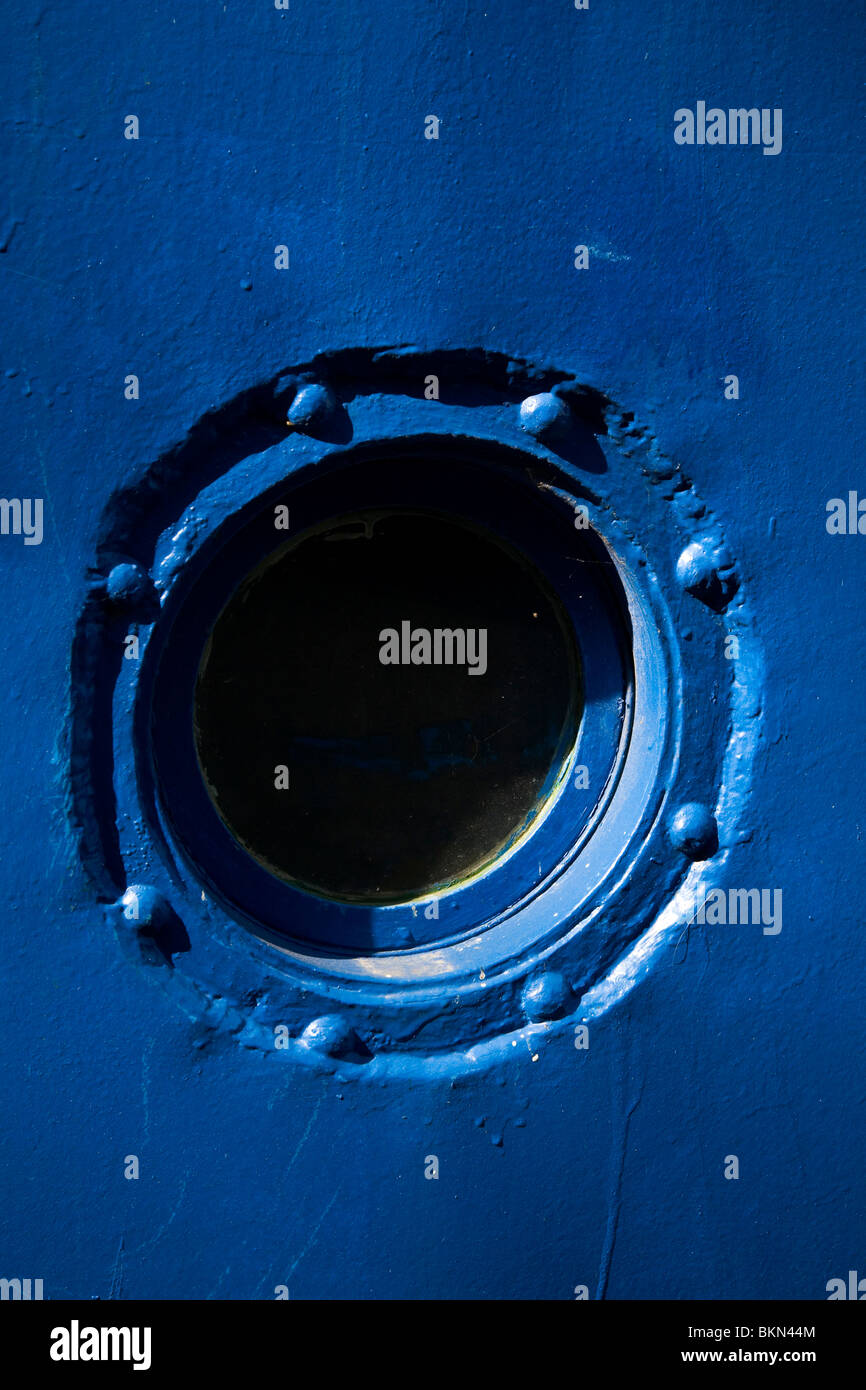 The port hole of a blue ship Stock Photo - Alamy