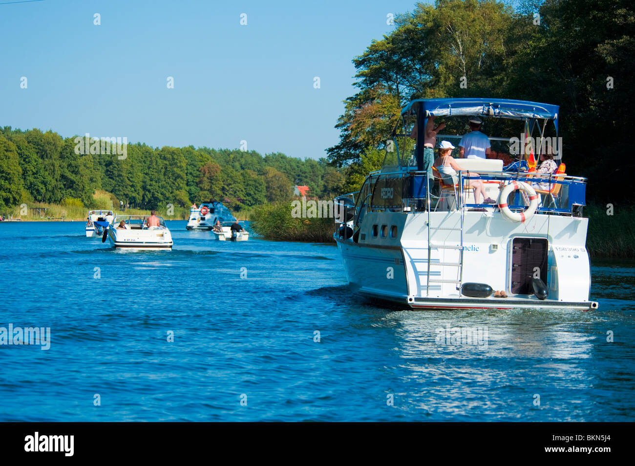 Charter boats entering canal from lake near Muritz, Mecklenburg Western ...