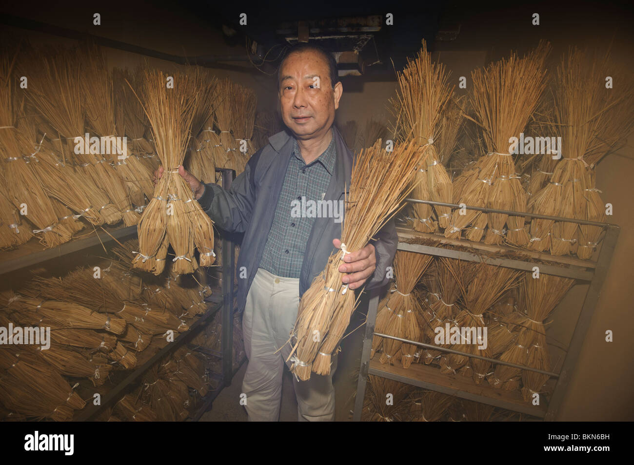 Mito Tengu Natto president Takashi Sasanuma holding straw wrapped natto ...