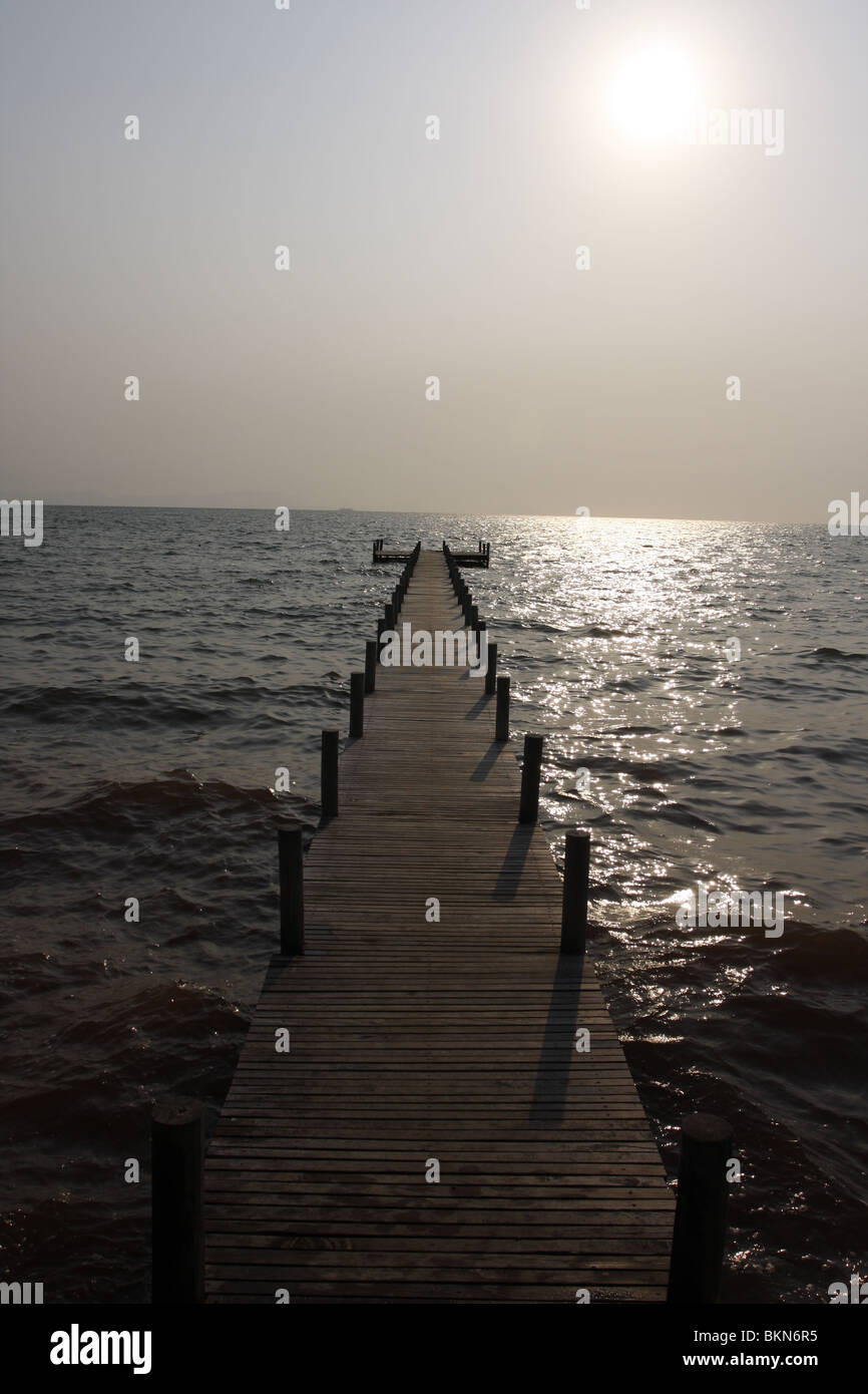 A rickety wooden pier stretches into the Golf of Thailand from the ...