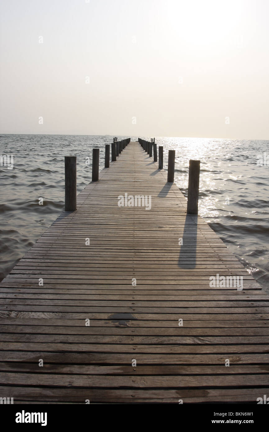 A rickety wooden pier stretches into the Golf of Thailand from the ...