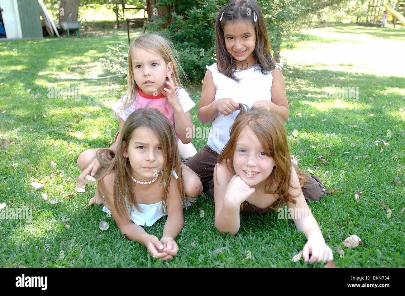 Girls playing in the garden Stock Photo - Alamy
