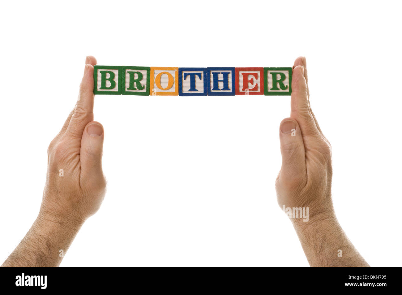 Man holding children's blocks that spell "BROTHER Stock Photo - Alamy