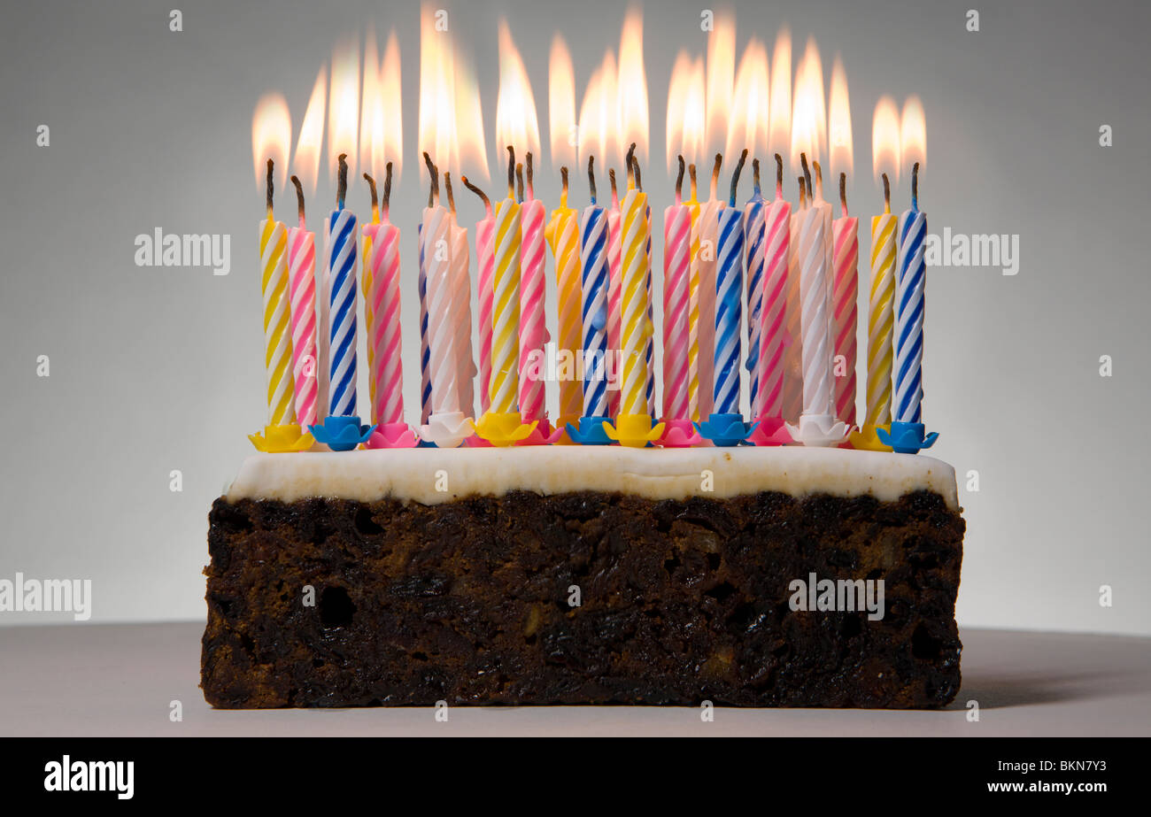 single cake with one candle burning down Stock Photo - Alamy