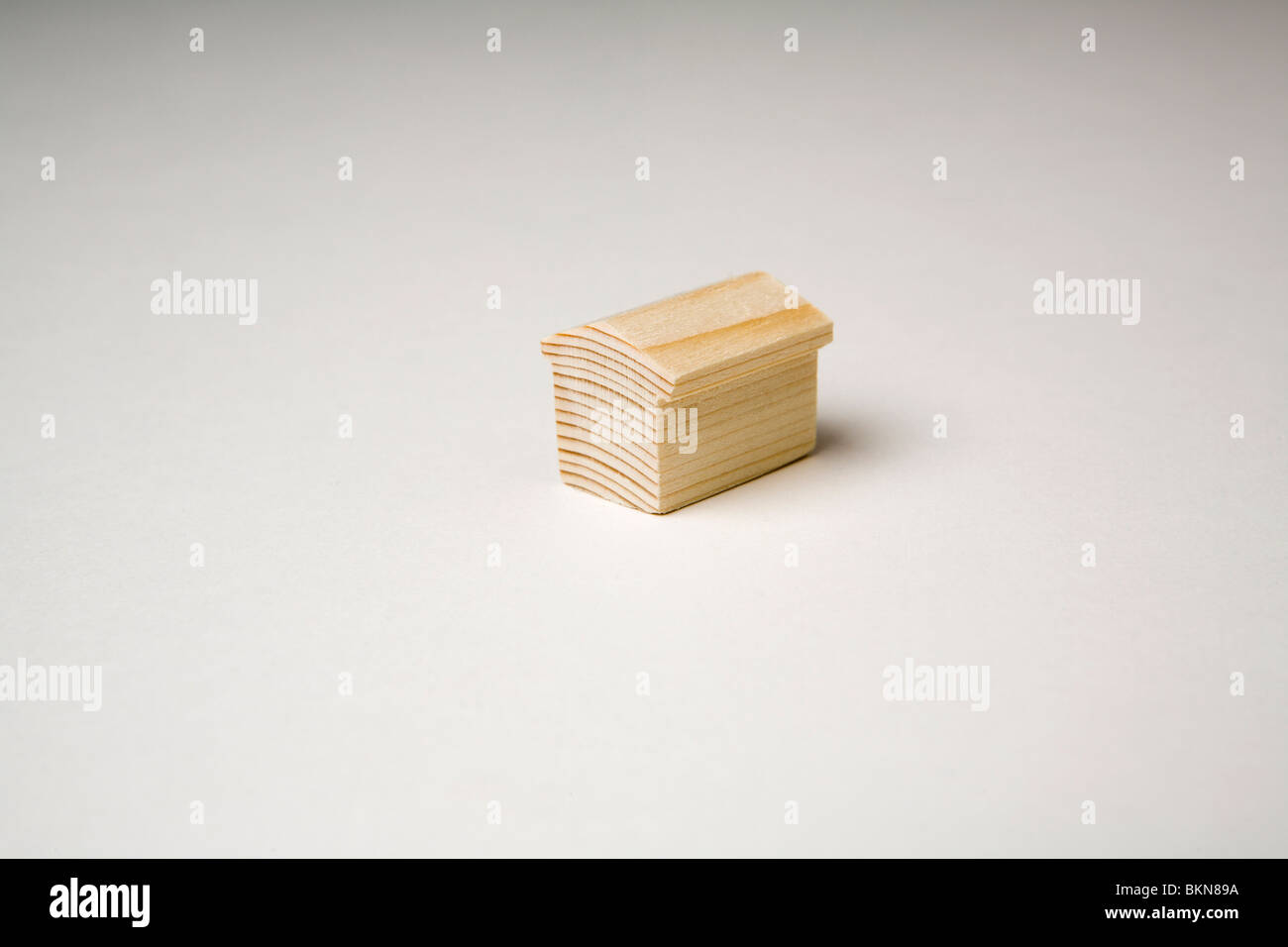 small wooden model house on plan white background Stock Photo - Alamy