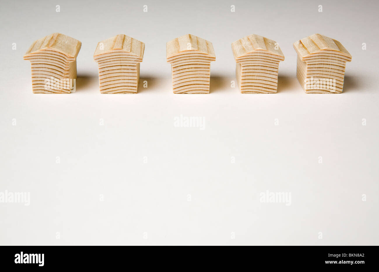 small wooden model house on plan white background Stock Photo - Alamy