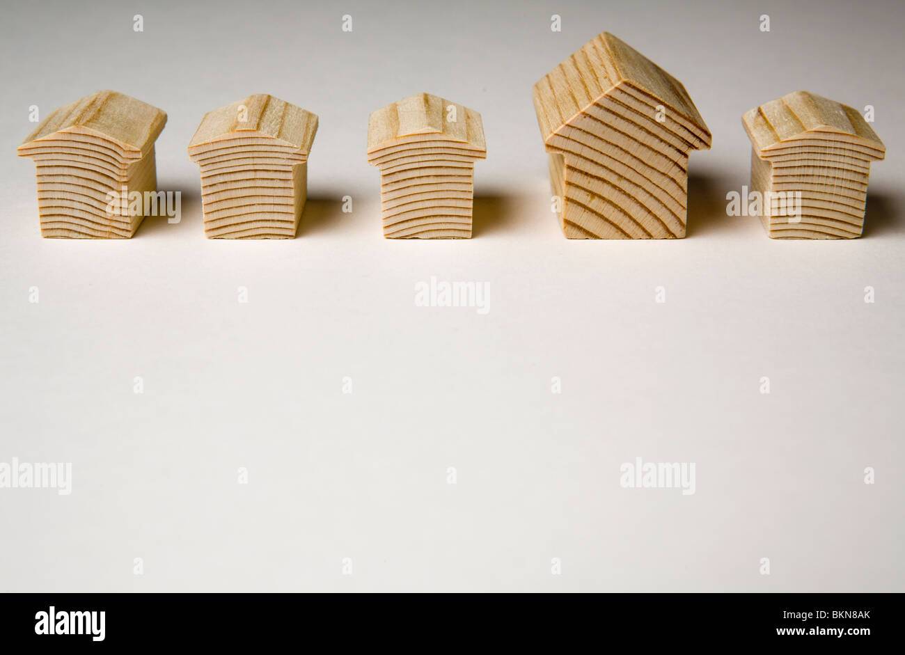 small wooden model house on plan white background Stock Photo - Alamy