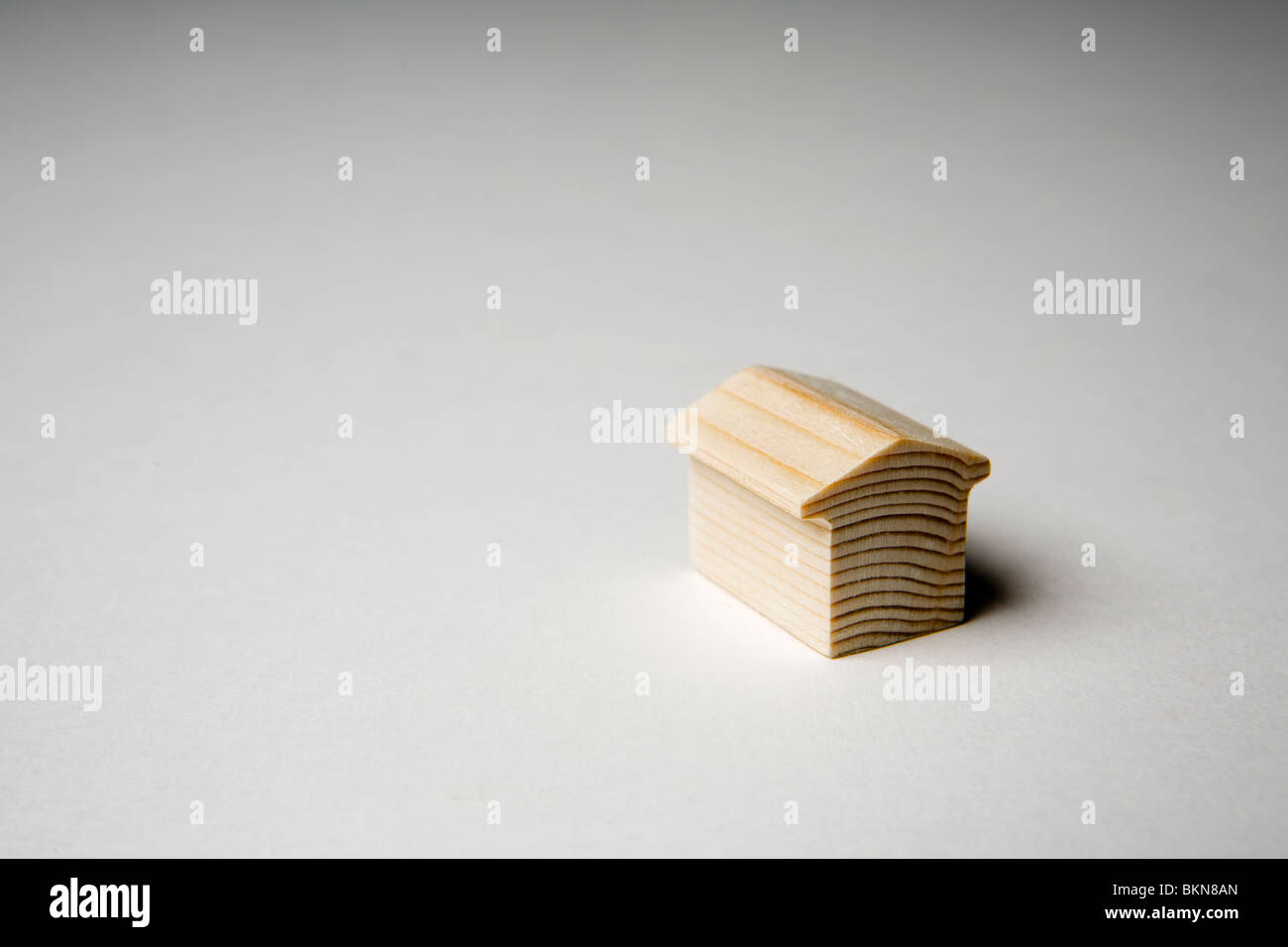 small wooden model house on plan white background Stock Photo - Alamy