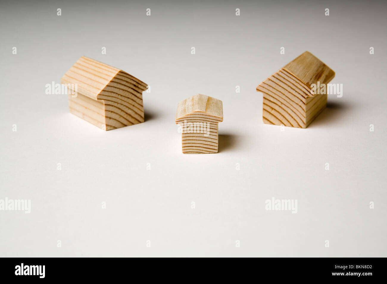 small wooden model house on plan white background Stock Photo - Alamy