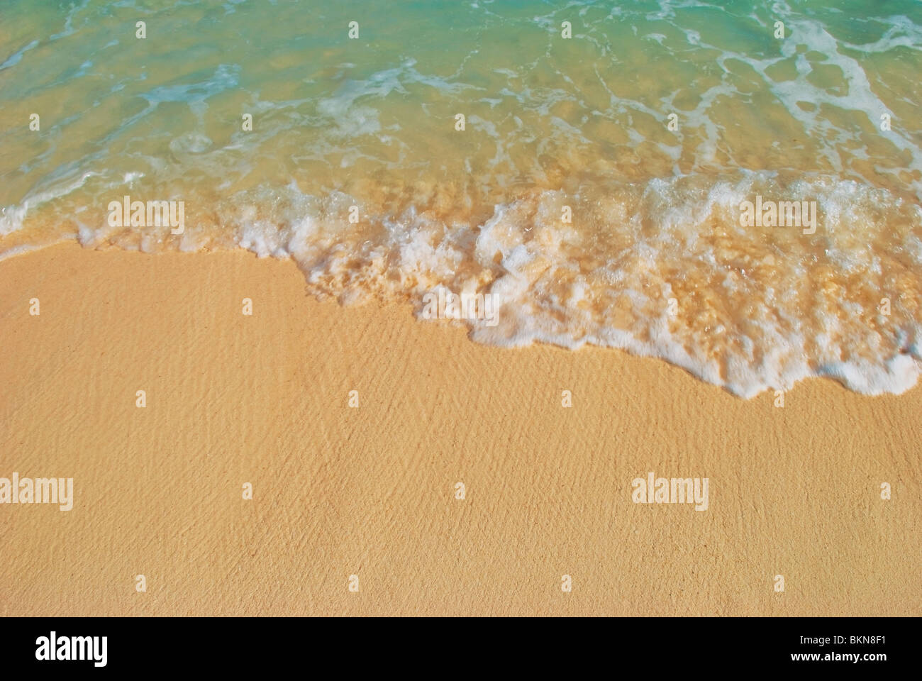 Water Washing Up On The Sand Stock Photo - Alamy