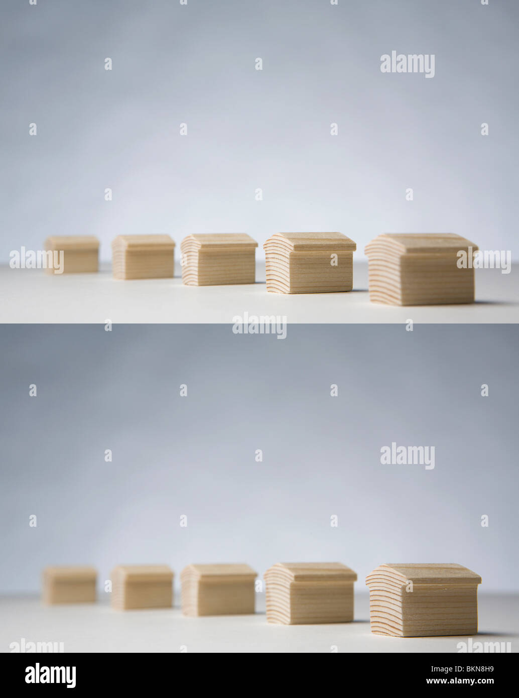 small wooden model house on plan white background Stock Photo - Alamy