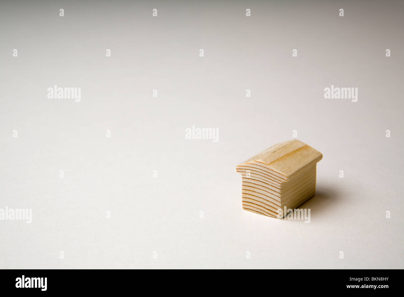 small wooden model house on plan white background Stock Photo - Alamy