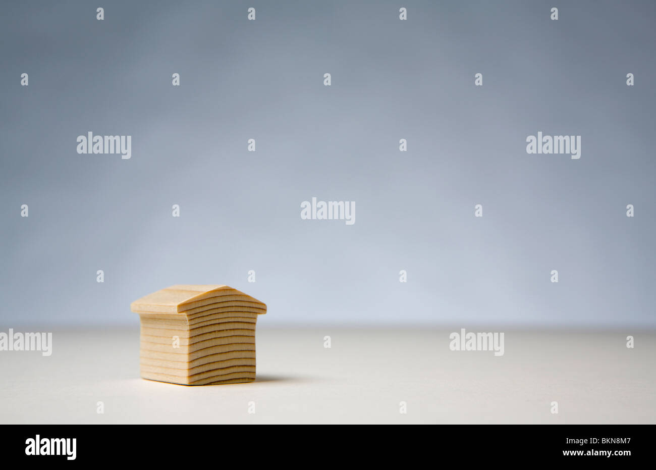 small wooden model house on plan white background Stock Photo - Alamy
