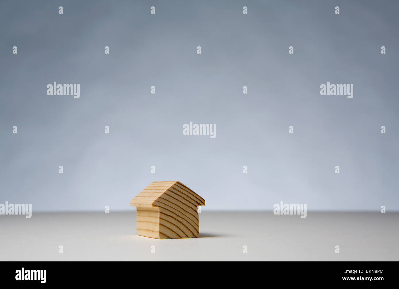 small wooden model house on plan white background Stock Photo - Alamy