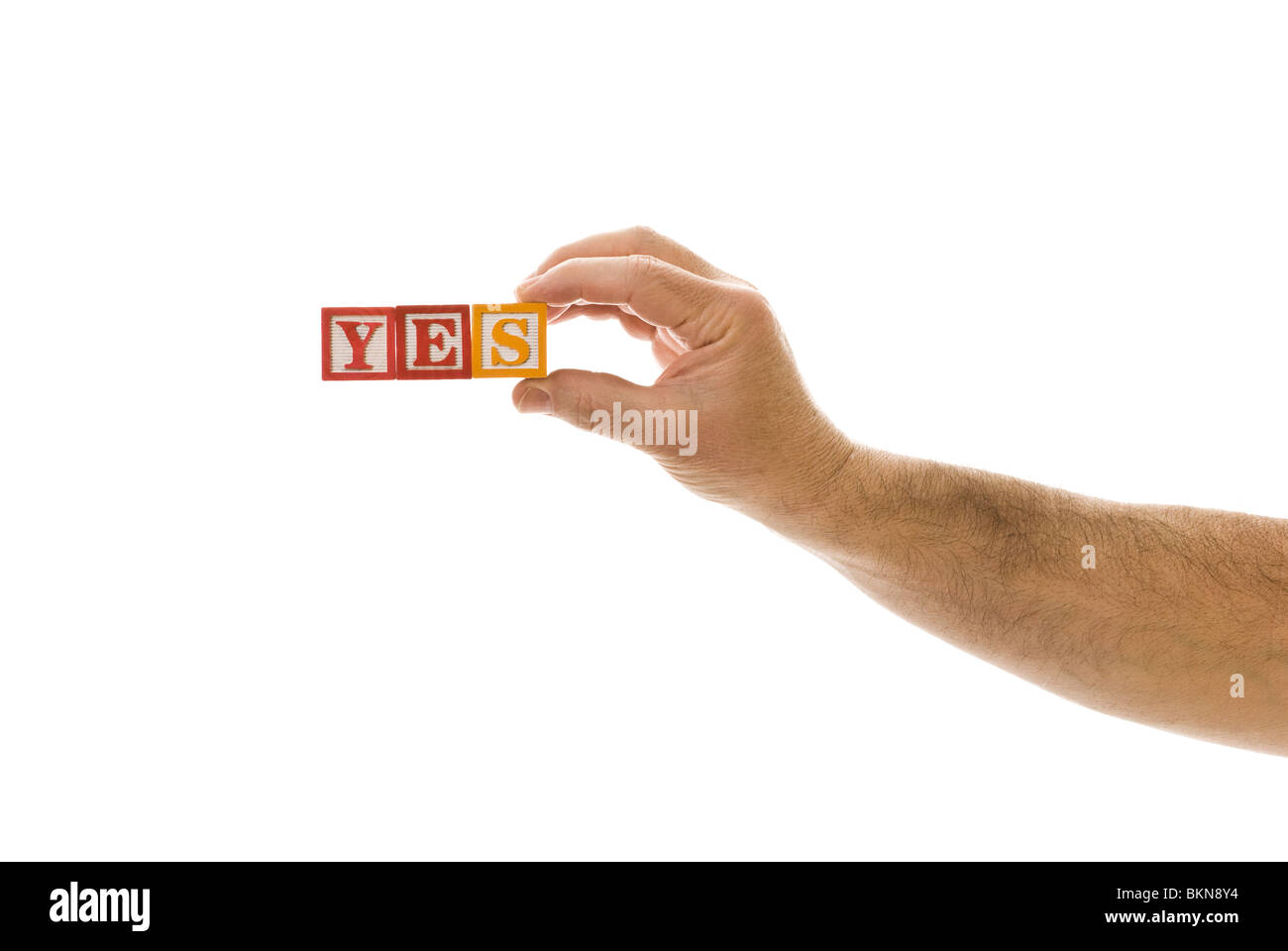Man holding children's blocks that spell "YES Stock Photo - Alamy