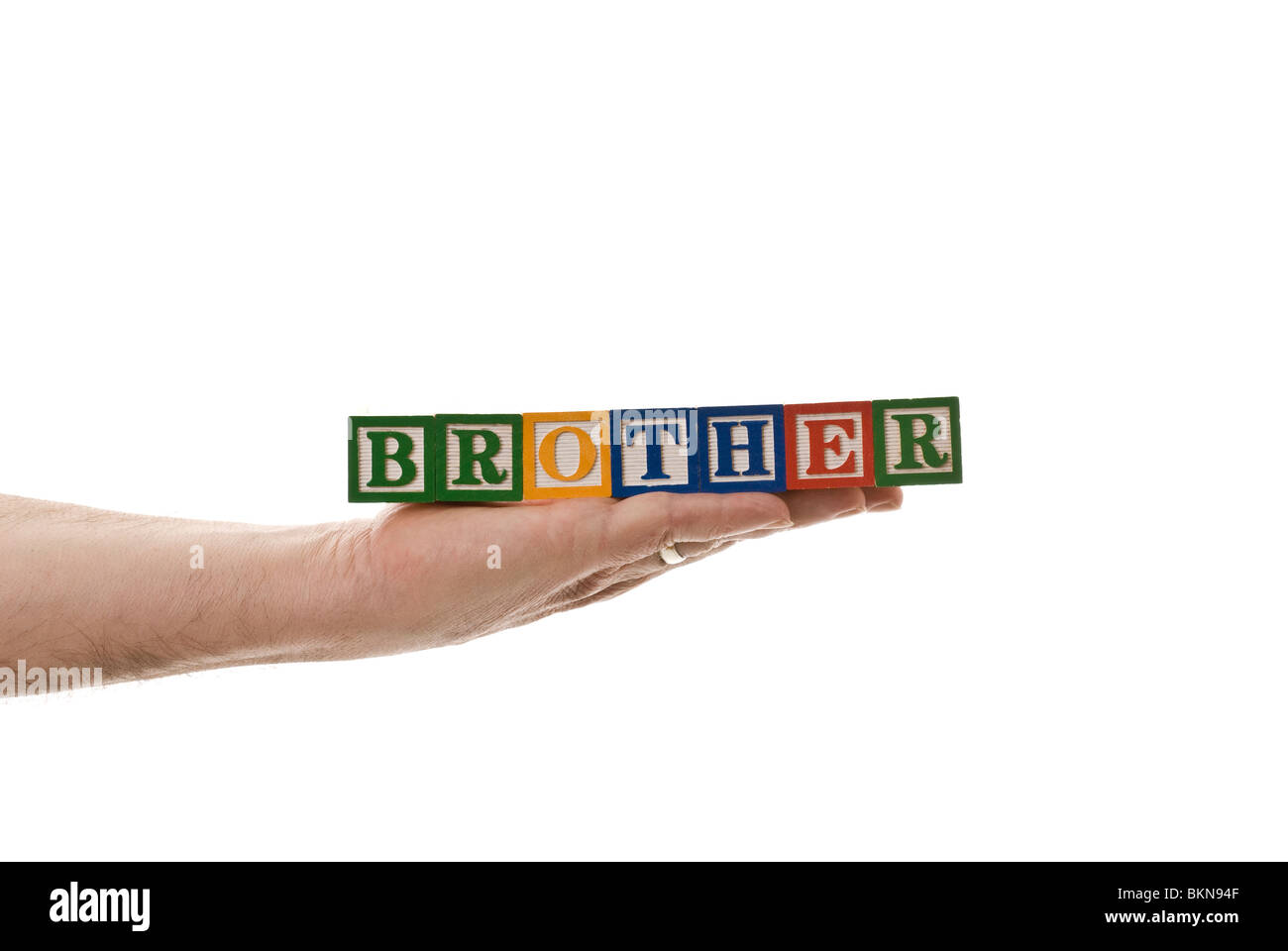 Man holding children's blocks that spell "BROTHER Stock Photo - Alamy