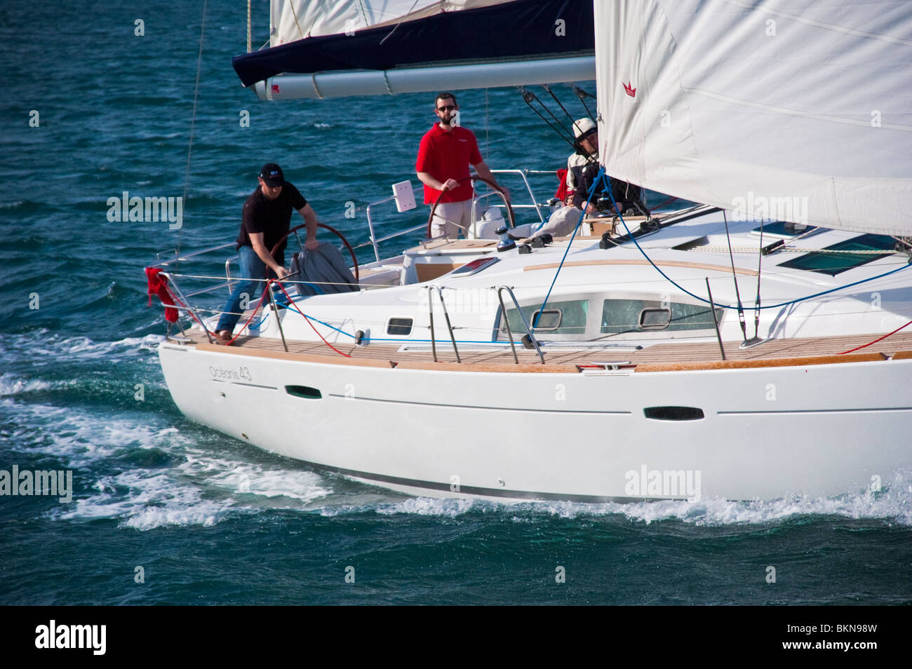 Helmsman or skipper with crew in cockpit of Beneteau Oceanis 43 ...