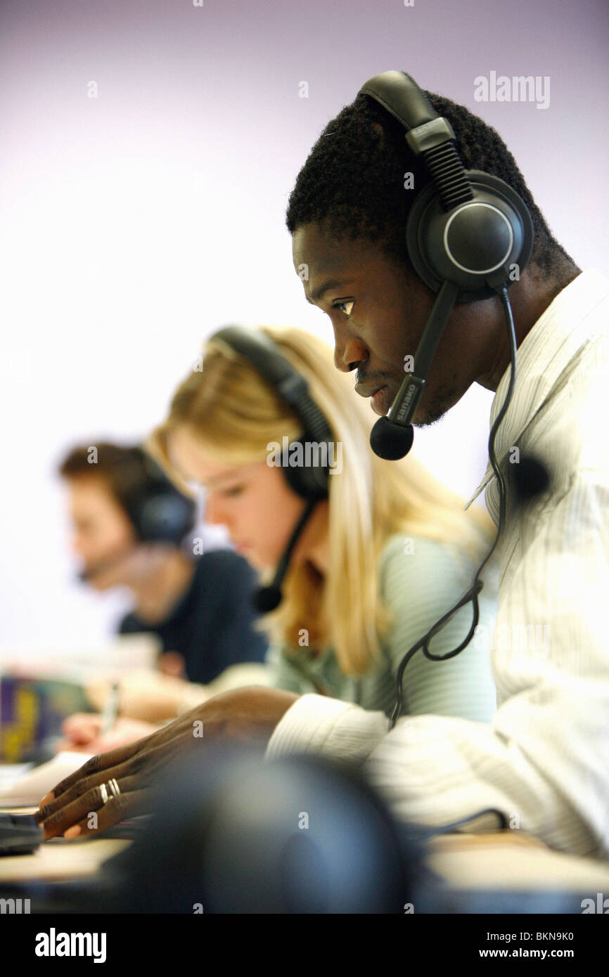 Student at university using headphones to study Stock Photo - Alamy