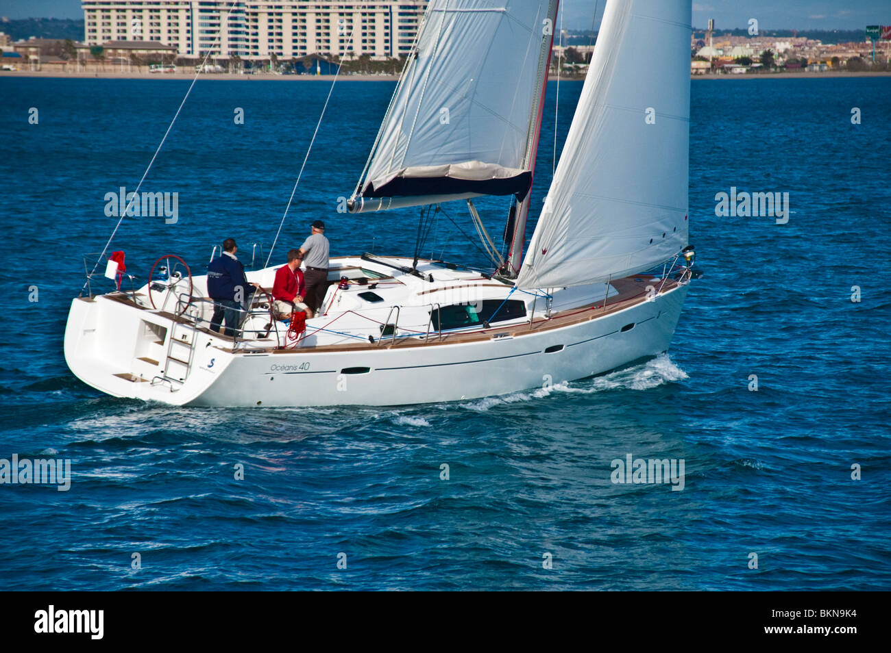 Helmsman or skipper with crew in cockpit of Beneteau Oceanis 40 ...