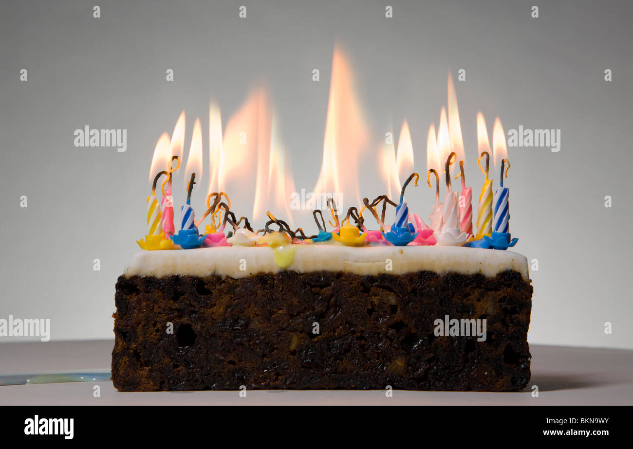 single cake with one candle burning down Stock Photo - Alamy
