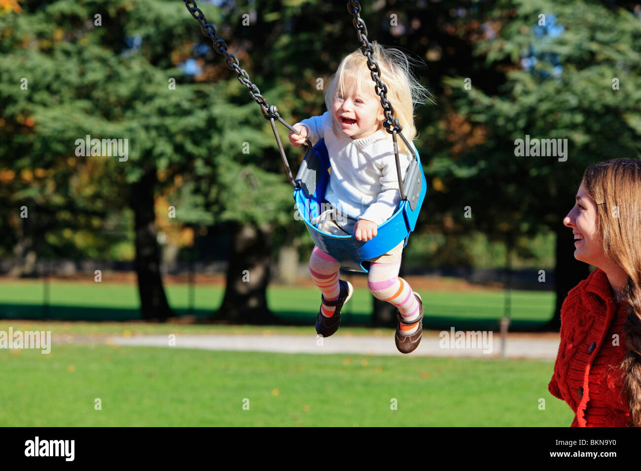 Children playing in swing set hi-res stock photography and images - Alamy