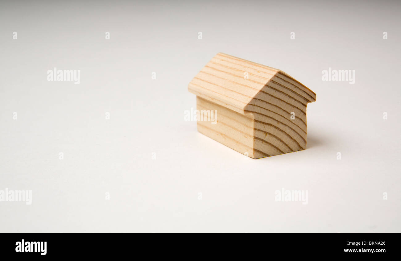 small wooden model house on plan white background Stock Photo - Alamy