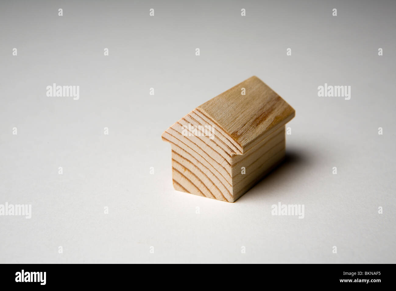 small wooden model house on plan white background Stock Photo - Alamy