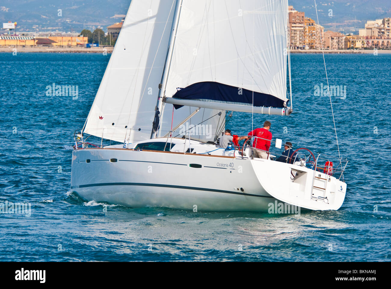 Helmsman or skipper with crew in cockpit of Beneteau Oceanis 40 ...