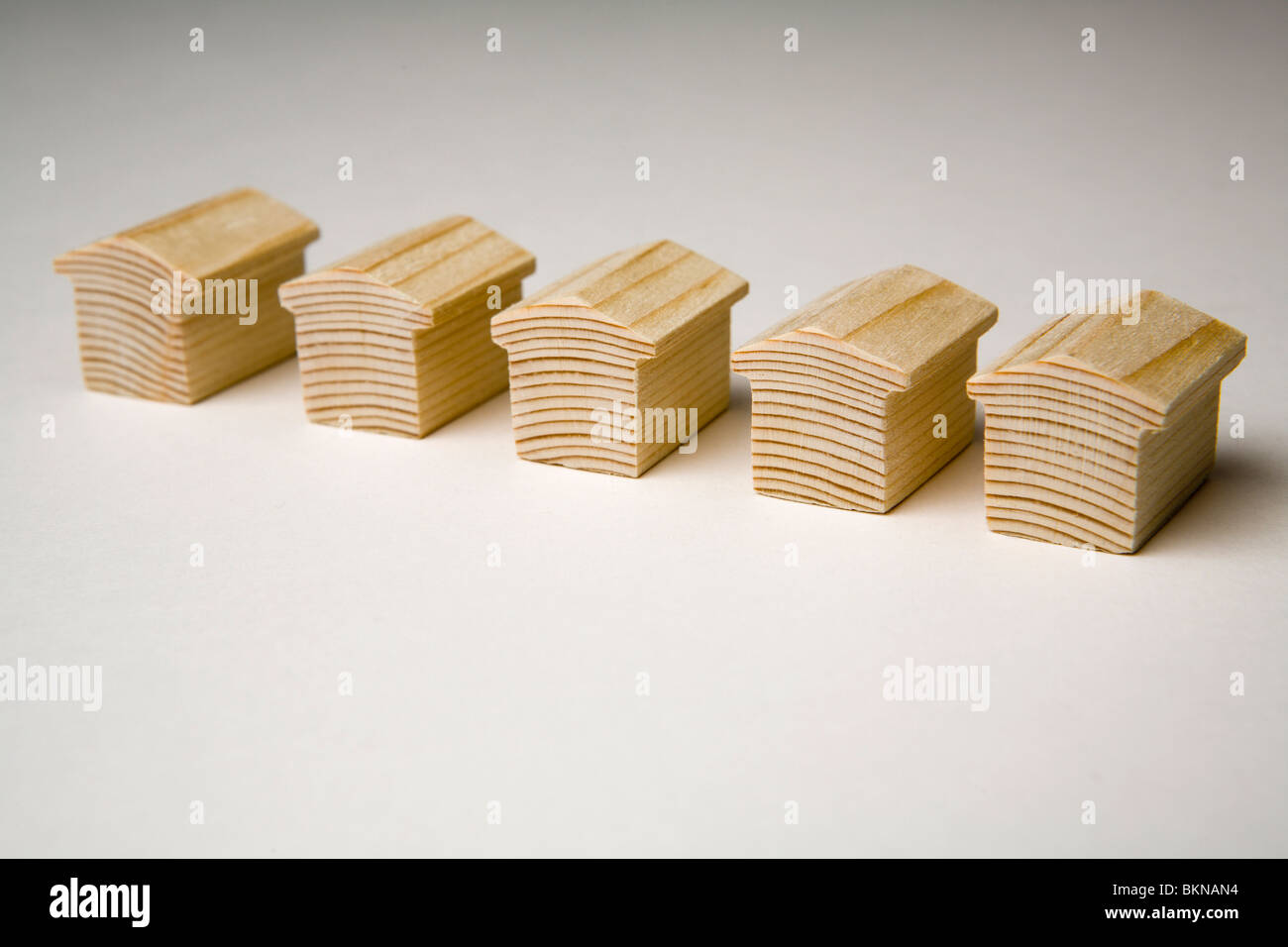 small wooden model house on plan white background Stock Photo - Alamy