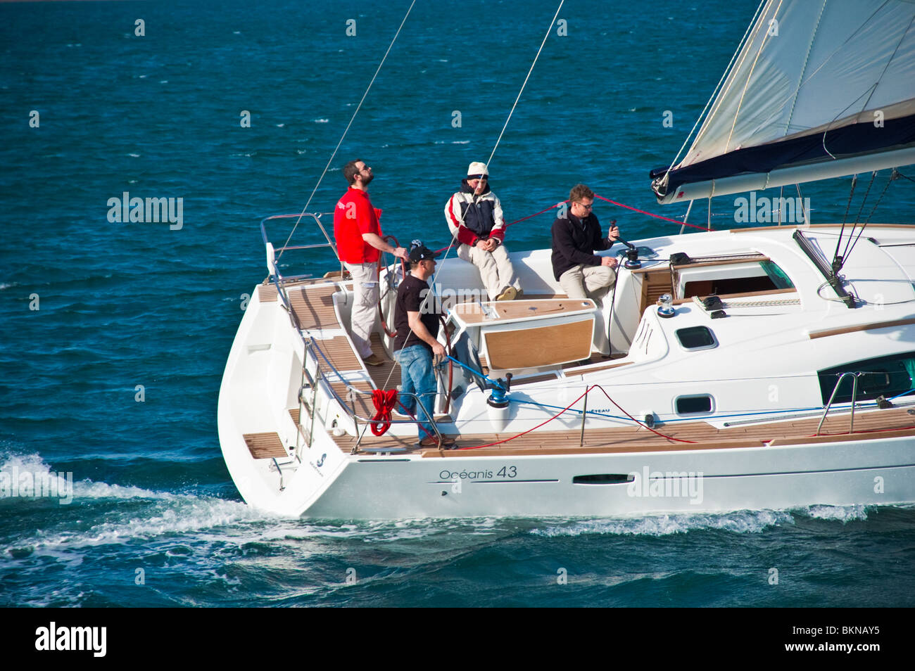 Helmsman or skipper with crew in cockpit of Beneteau Oceanis 43 ...