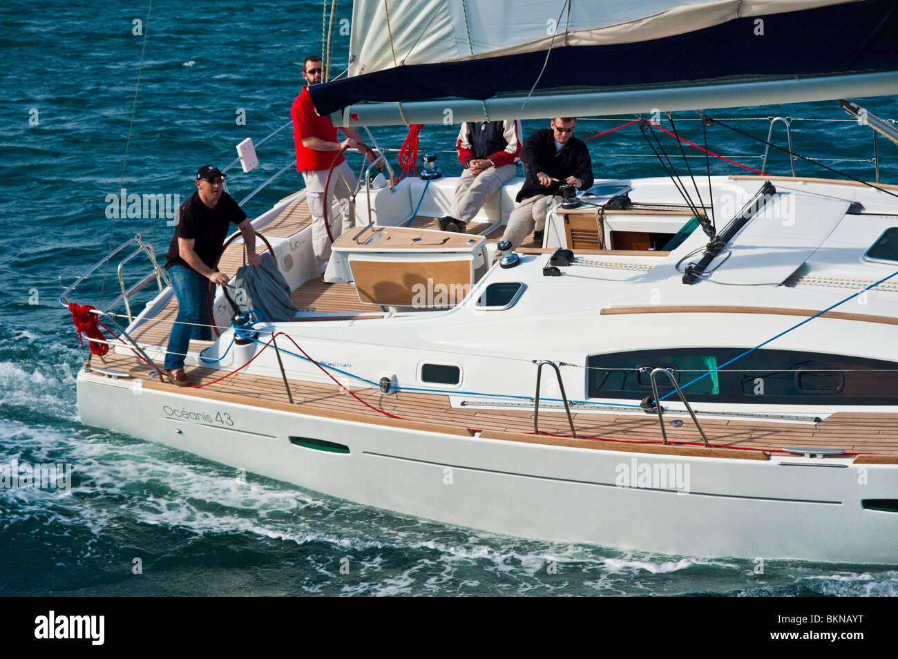 Helmsman or skipper with crew in cockpit of Beneteau Oceanis 43 ...
