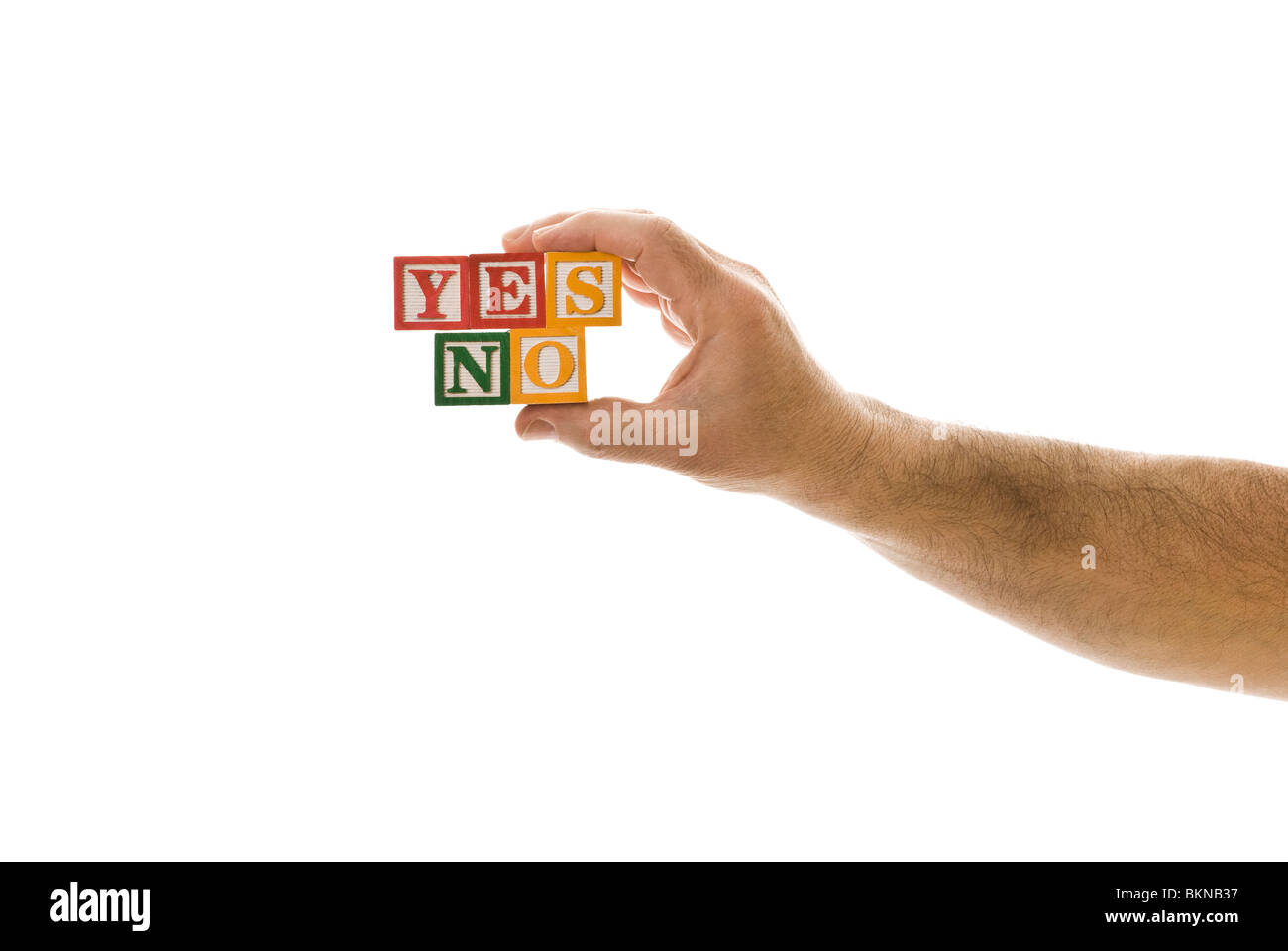 Man holding children's blocks that spell "YES" "NO Stock Photo - Alamy