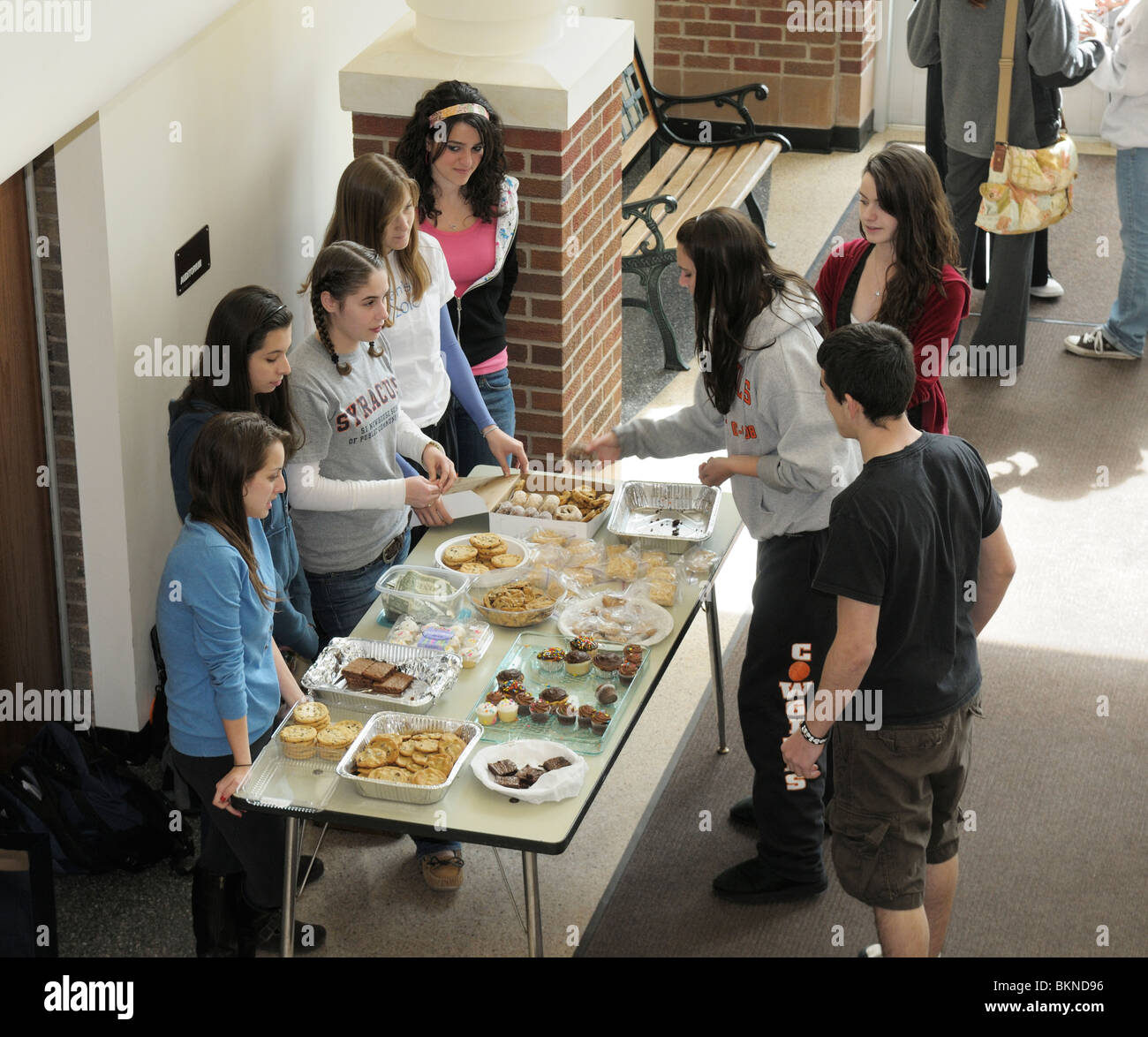 High school students gathering at an after school bake sale fund raiser ...