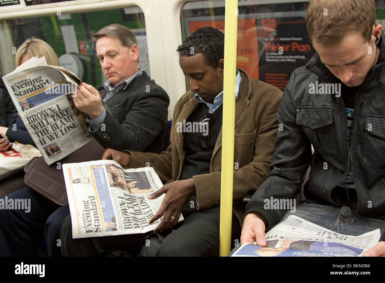 Commuters reading Evening Standard - London Underground Train Stock ...