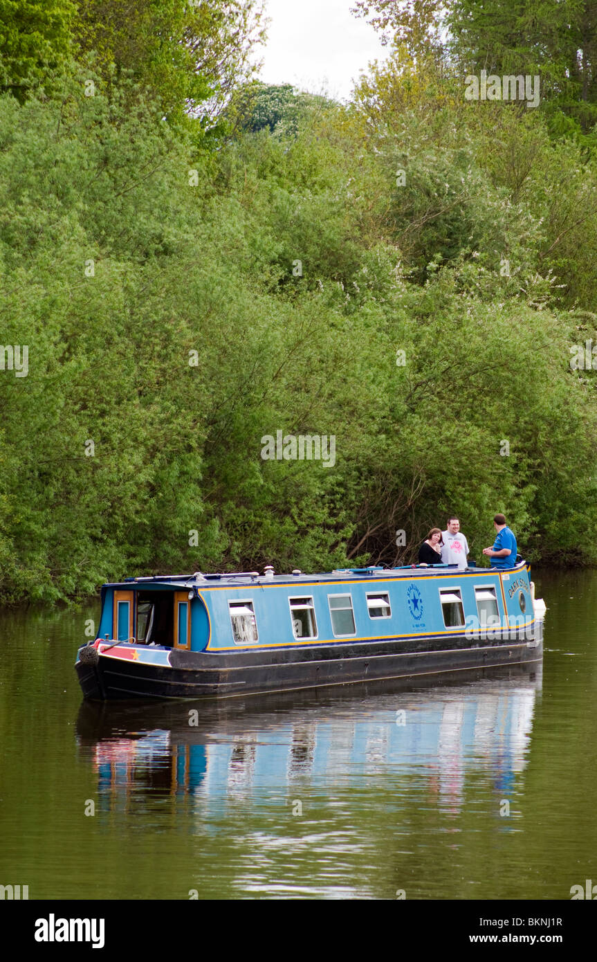 A blue narrowboat making its way along the River Severn at Upton-upon ...