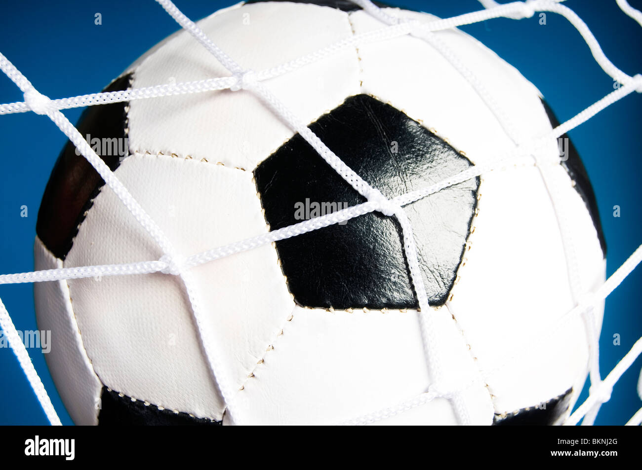 a soccer ball into the net, concept for goal Stock Photo - Alamy