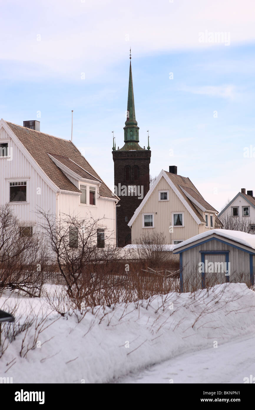 Narvik Church spire amongst typical wooden houses in the port of Narvik ...