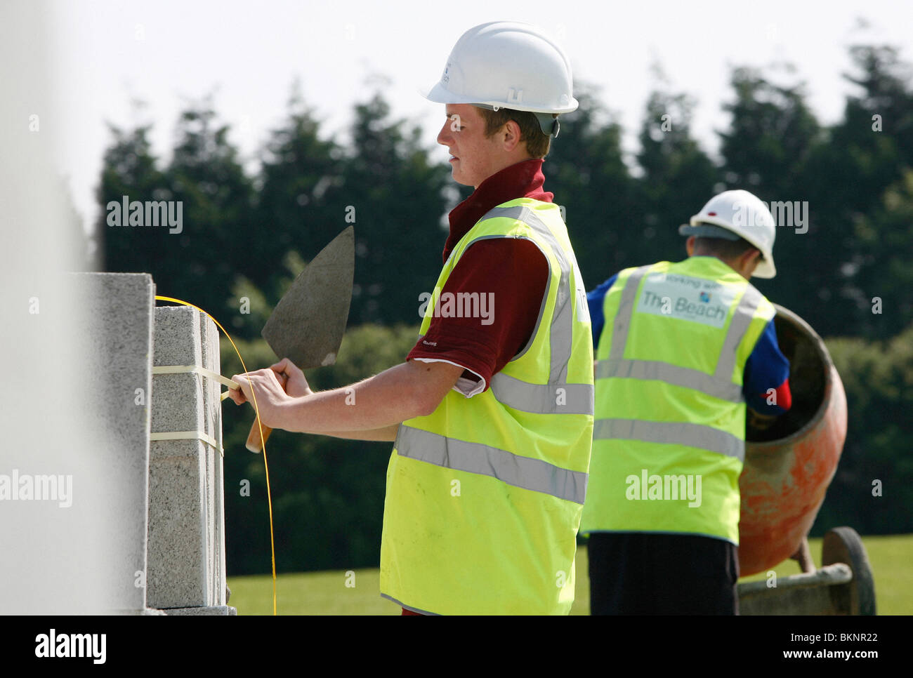 Building apprentices on a building site Stock Photo - Alamy