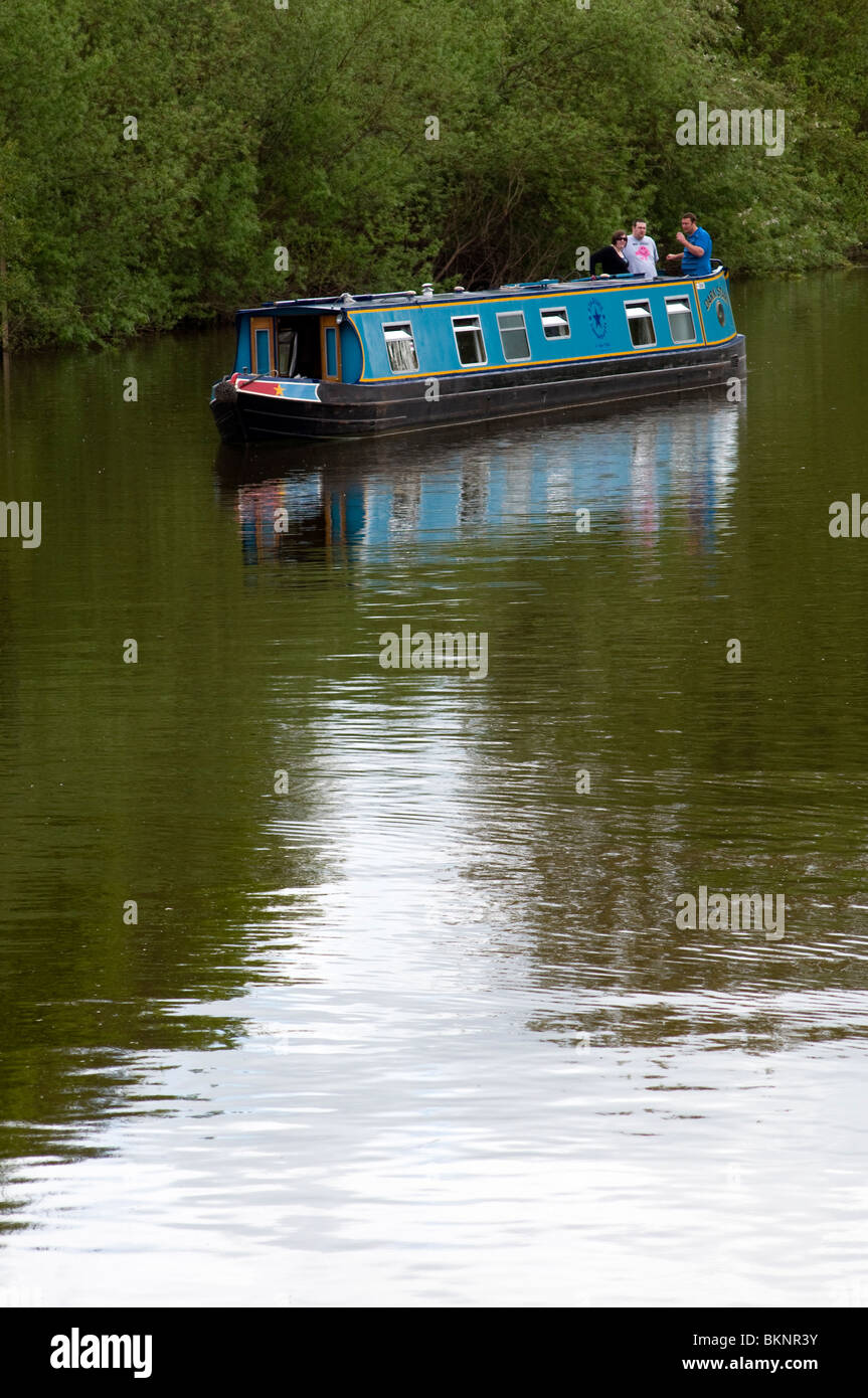 A blue narrowboat making its way along the River Severn at Upton-upon ...