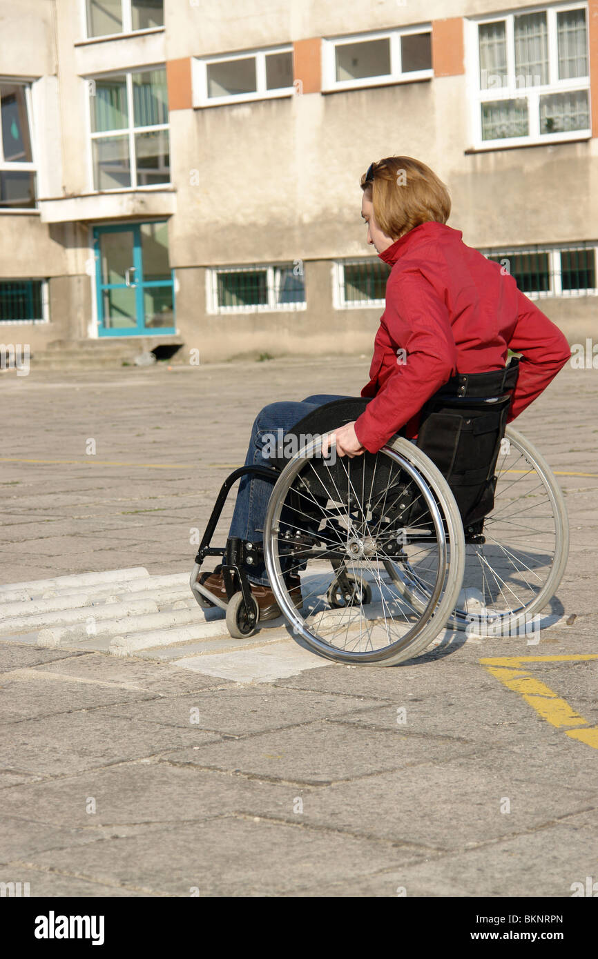 Handicapped woman practicing wheelchair ride over obstacle course for ...