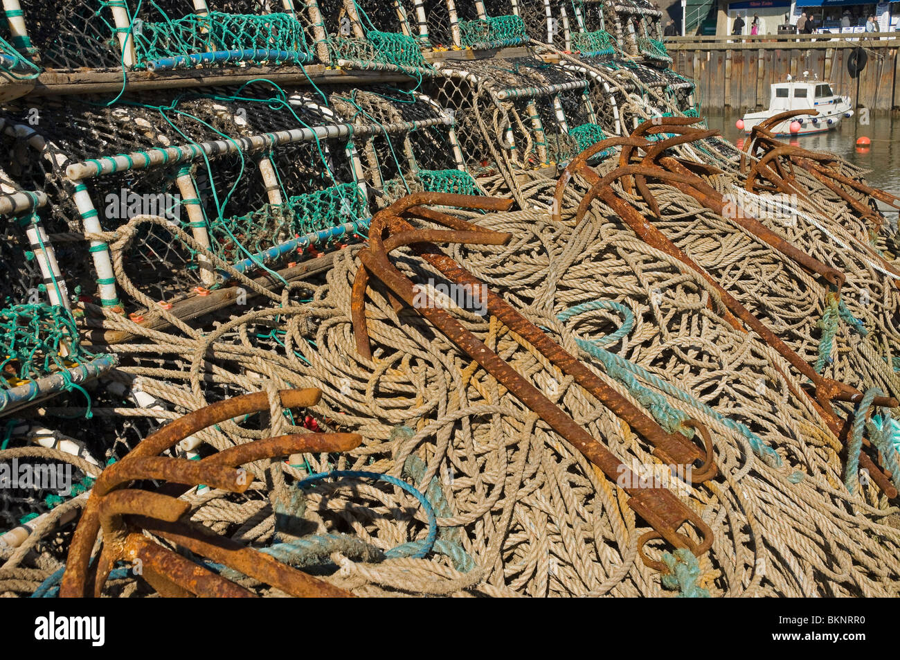 Rusty anchors anchor on pile of ropes on the quayside Bridlington East ...